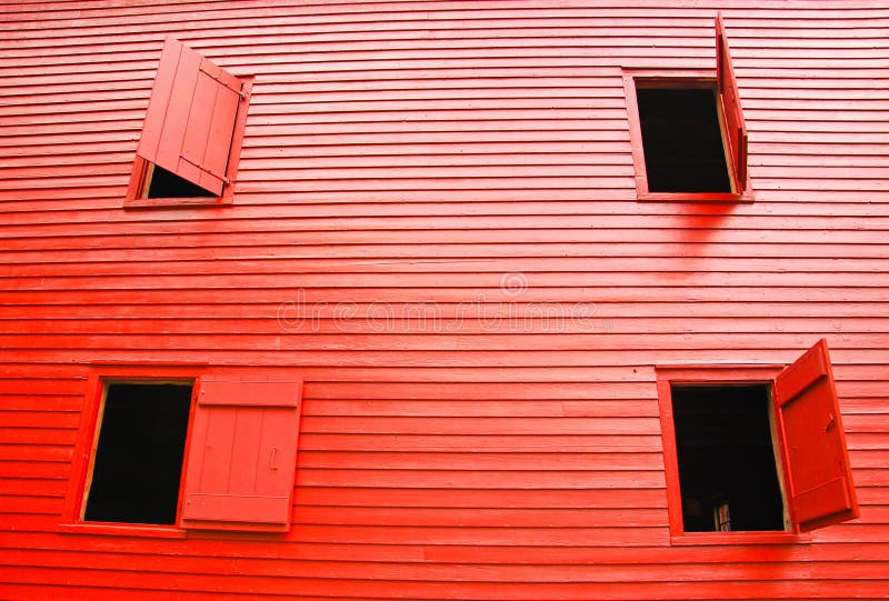Bright Red Barn Wall with Four Asymmetrical Open Windows with Shutters ...