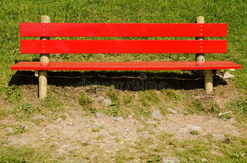 Bright Red Bench on a Green Meadow Stock Photo - Image of stones, wood ...