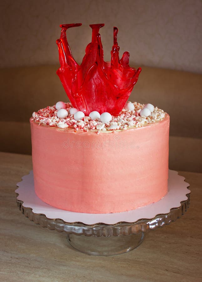 Bright Red Birthday Cake with Caramel Decoration on the Table Stock ...