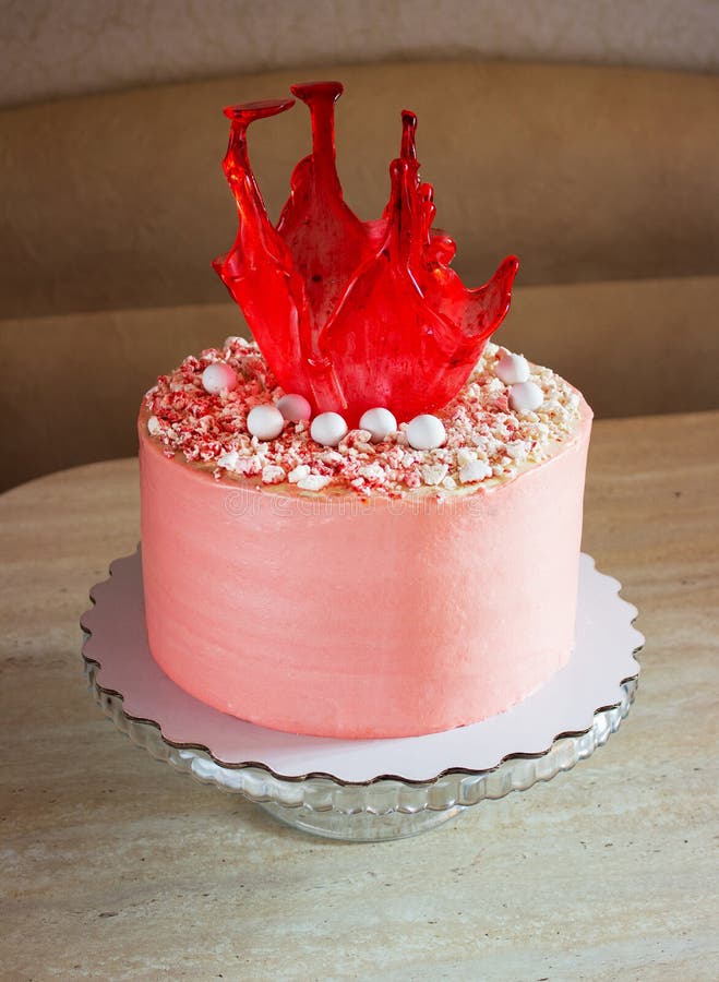 Bright Red Birthday Cake with Caramel Decoration on the Table Stock ...