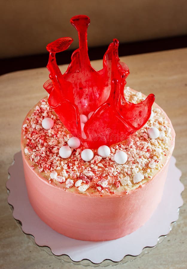 Bright Red Birthday Cake with Caramel Decoration on the Table Stock ...