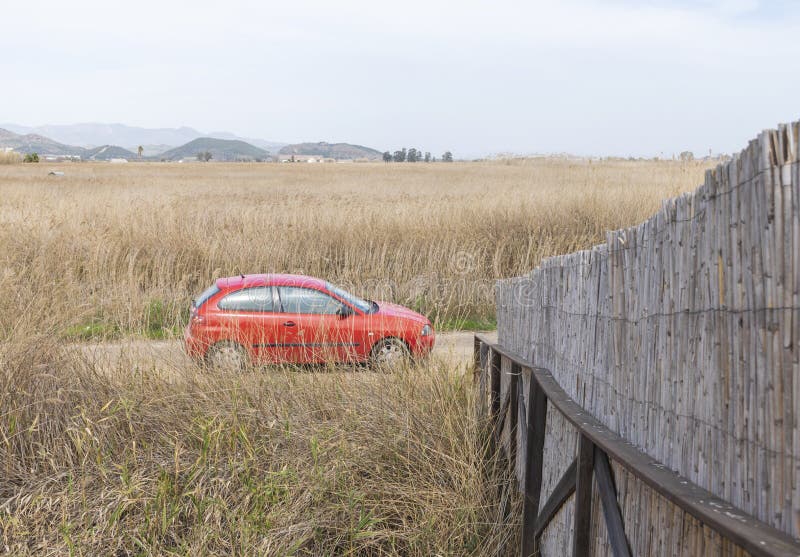 Bright Red Car Parked in a Brown Dry Field Stock Image - Image of ...