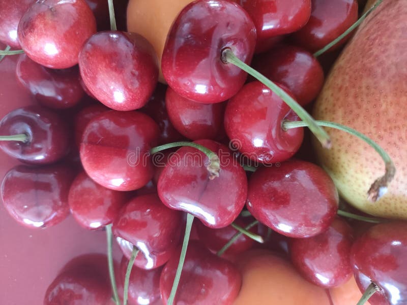 The Bright Red Cherries and Pink Pears Close Up Stock Photo - Image of ...