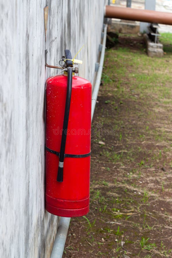 Red Fire Extinguisher Mounted on Concrete Wall in Industrial Area ...