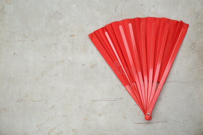 Bright Red Hand Fan on Old Light Grey Background, Top View. Space for ...