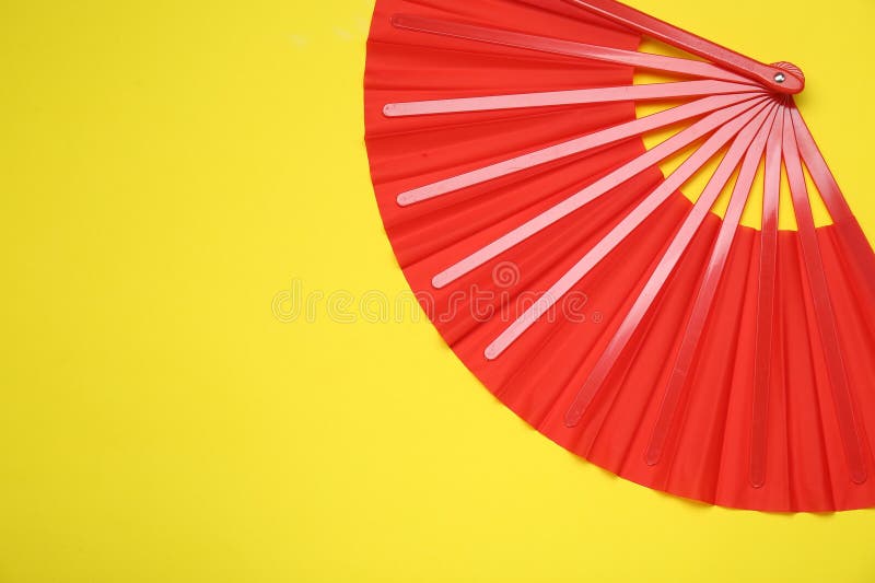 Bright Red Hand Fan on Yellow Background, Top View. Space for Text ... Bright Red Hand Fan on Yellow Background, Top View. Space for Text ...