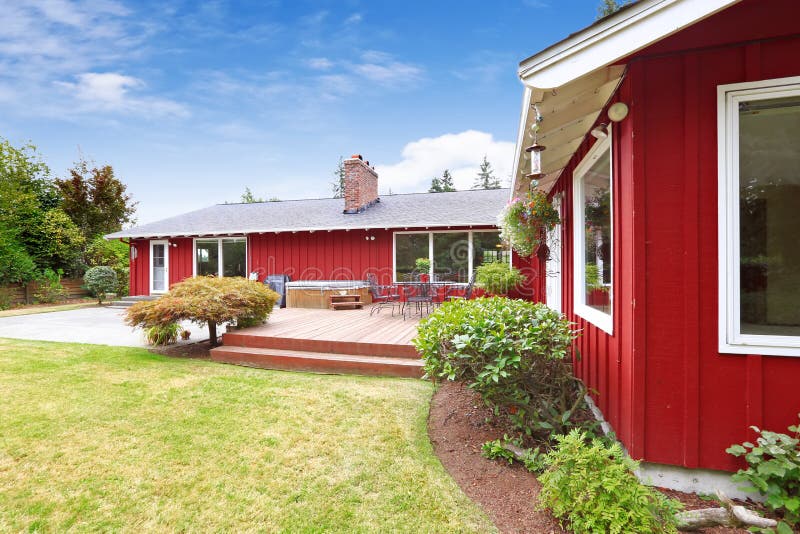 Bright Red House with Walkout Deck and Patio Area Stock Image - Image ...