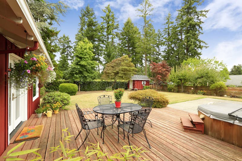 Bright Red House with Walkout Deck and Patio Area Stock Image - Image ...