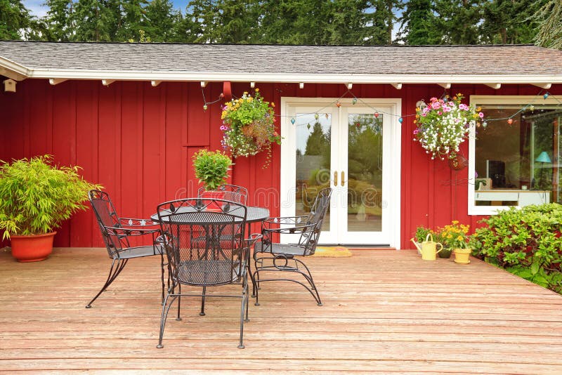 Bright Red House with Walkout Deck and Patio Area Stock Image - Image ...