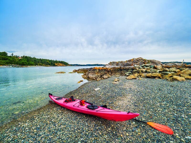 Bright Red Kayak on a Pebble Ocean Beach Stock Image - Image of ...