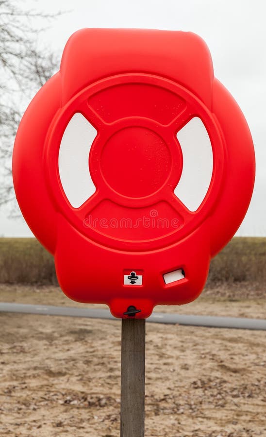 Bright Red Lifebuoy Case on Wooden Pole Stock Image - Image of coast ...