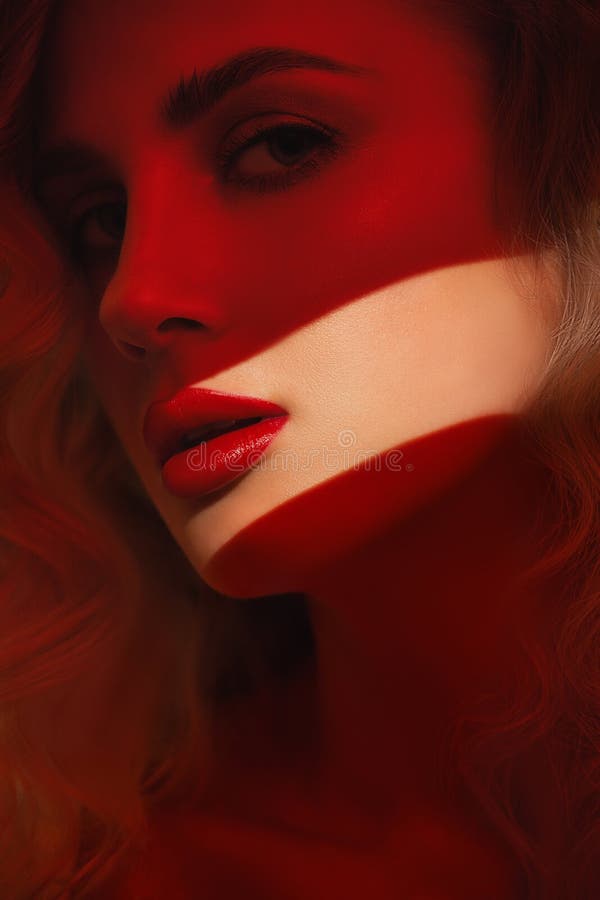 Bright Red Lips of Blonde Woman Highlighted by a Streak of Light Stock ...