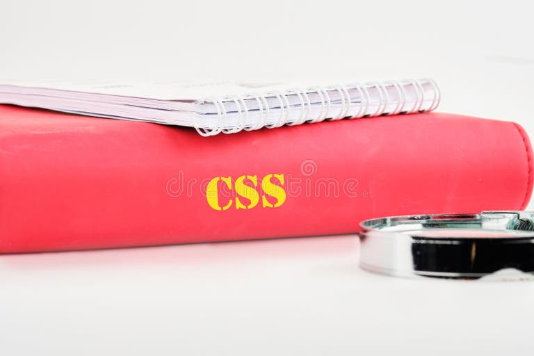 A Bright Red Notebook Labeled with CSS is Placed Next To a Magnifying ...