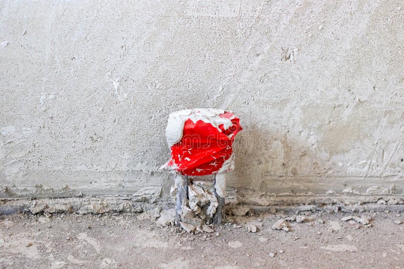 A Bright Red Object is Resting on the Ground in Front of a Pure White ...