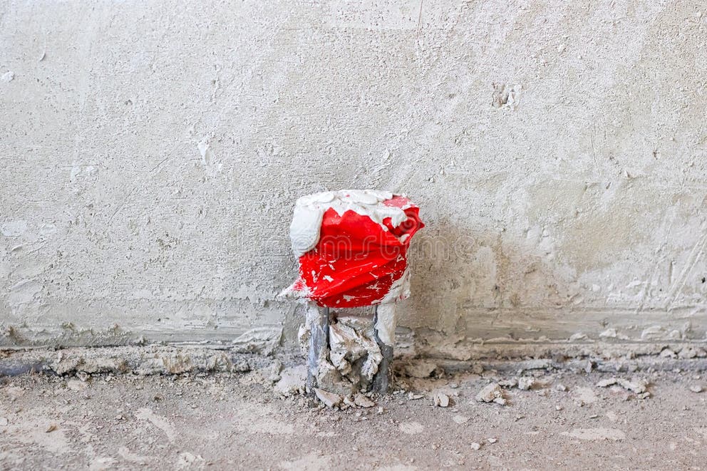 A Bright Red Object is Resting on the Ground in Front of a Pure White ...