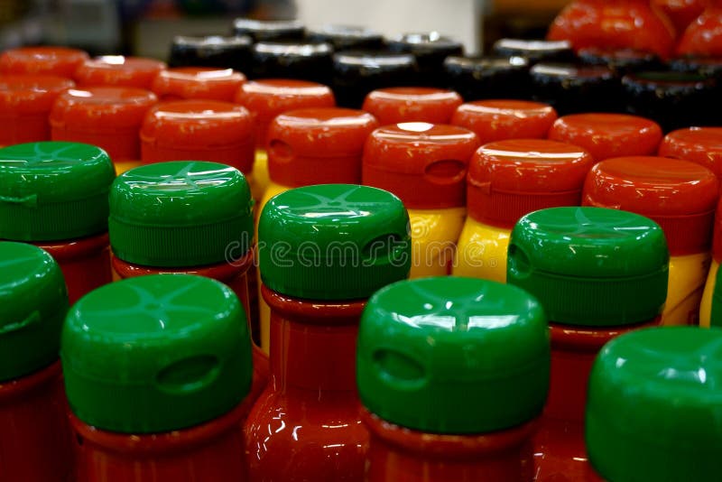 Bright Red Plastic Bottles with Green Caps, Closeup Stock Photo - Image ...