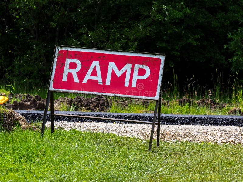 Bright Red RAMP Sign on a Grassy Construction Site, with Greenery in ...