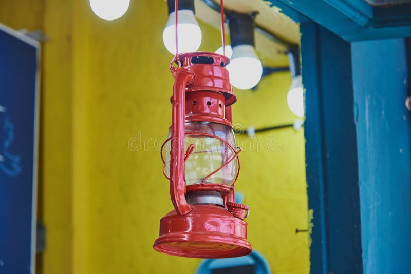A Bright Red Retro Lantern Hangs in an Open Cafe Against a Yellow Wall ...
