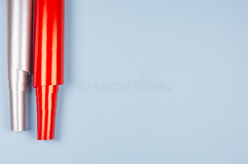 Bright Red and Silver Wrapping Paper Rolls on Soft Pastel Blue ...