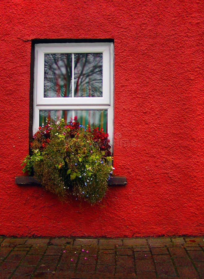 Bright Red Wall with Window Adorned by Vibrant Flower Box and Greenery ...