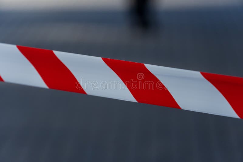 Bright Red and White Caution Tape Stretches Across a City Street ...