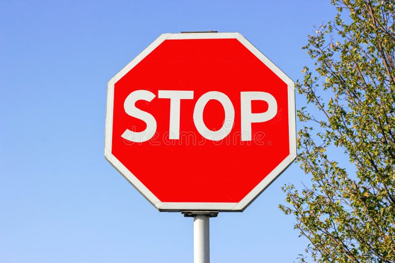 Bright Red and White Stop Traffic Sign Against the Blue Sky. Stock ...