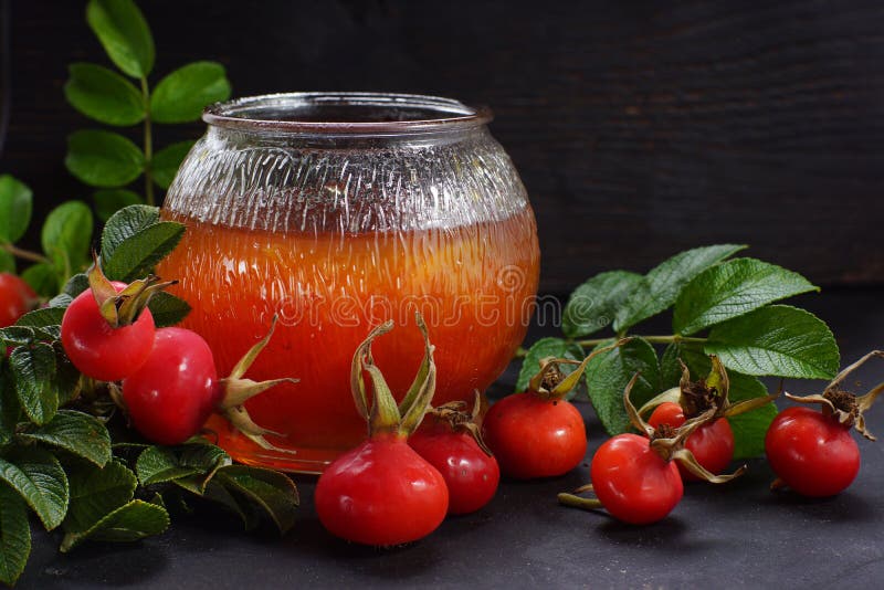 Bright Rosehip Jam in a Jar on the Background of Leaves and Wild Rose ...