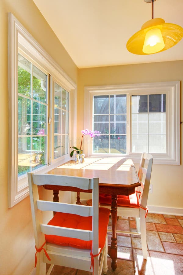 Bright Small Dining Area with Tile Floor and Large Windows. Stock Photo ...