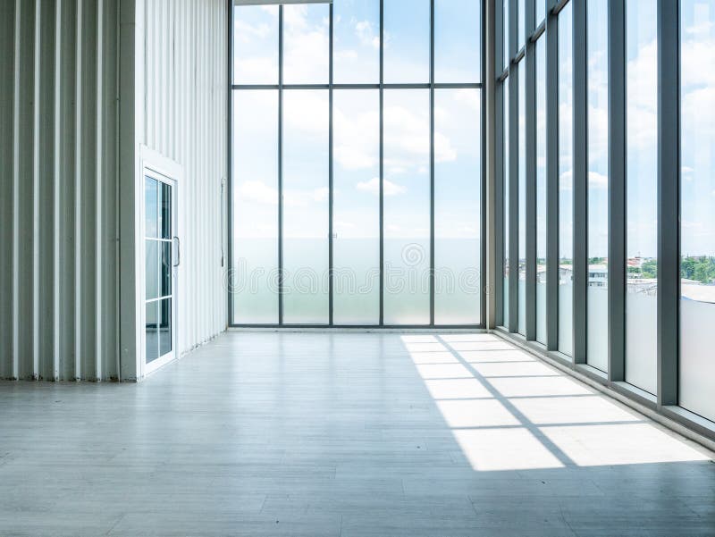A Bright and Spacious Empty Room with Large Floor To Ceiling Windows ...
