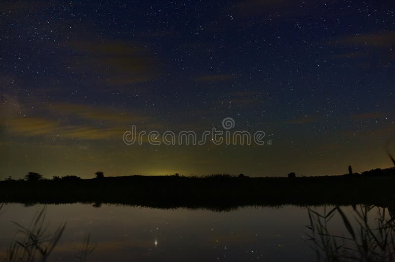 Bright Stars with Clouds Over the River in the Night Sky. Outer Space ...