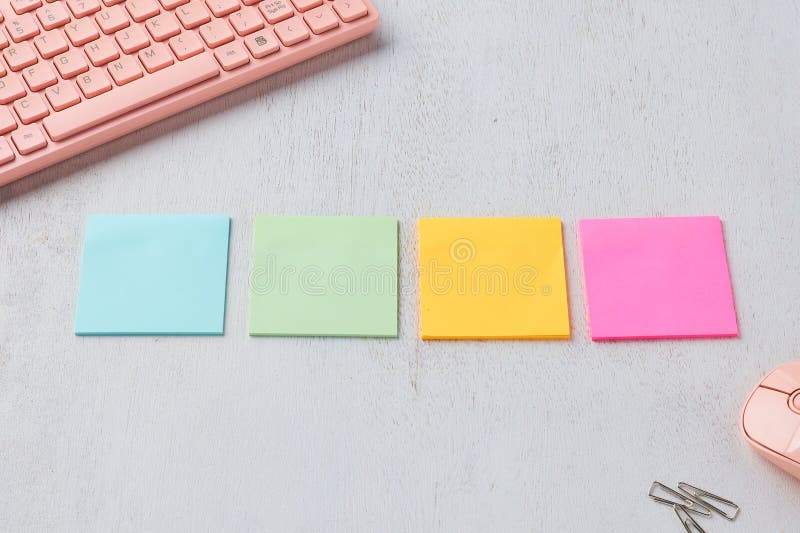 Colorful Sticky Notes Arranged on a Desk with a Pink Keyboard and Mouse ...