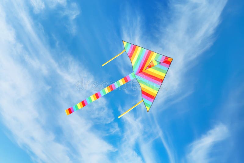 Bright Striped Rainbow Kite Flying in Blue Sky on Sunny Day Stock Image ...