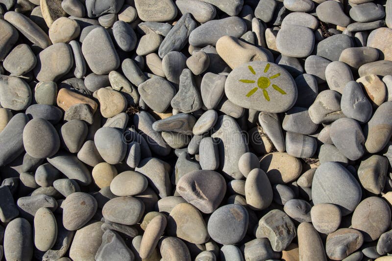 Bright Sun Painted on Pebble. Pebbles Background Stock Photo - Image of ...
