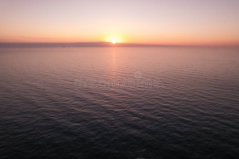 Sun setting over sea water stock image. Image of evening - 258864855