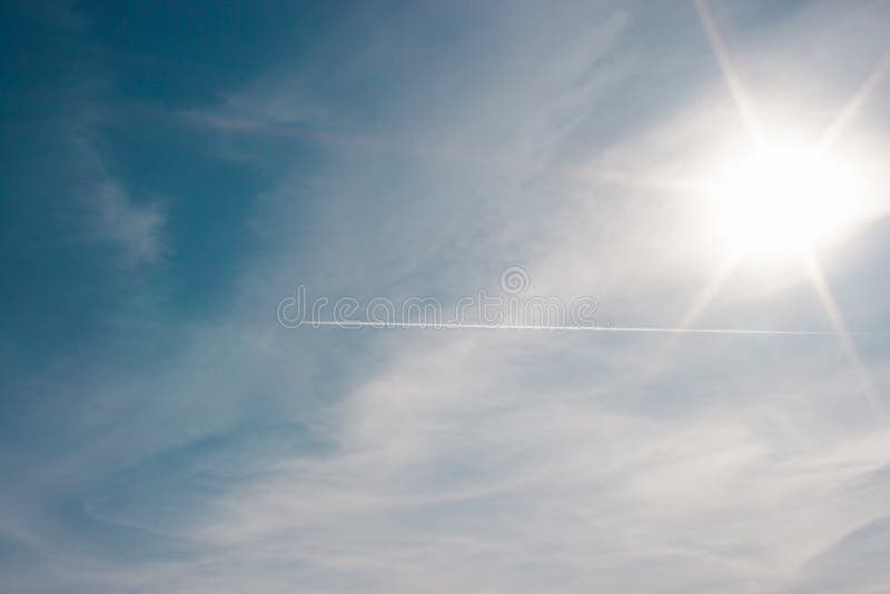 A Bright Sun and a Trace of an Airplane Passing from the Side of the ...