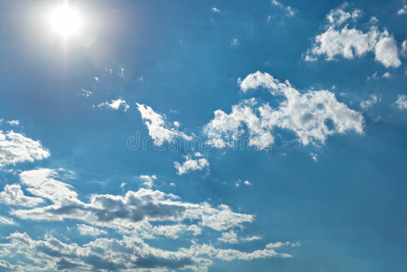 Bright Sun, White Heap Clouds and Bright Sun in the Blue Sky. Stock ...