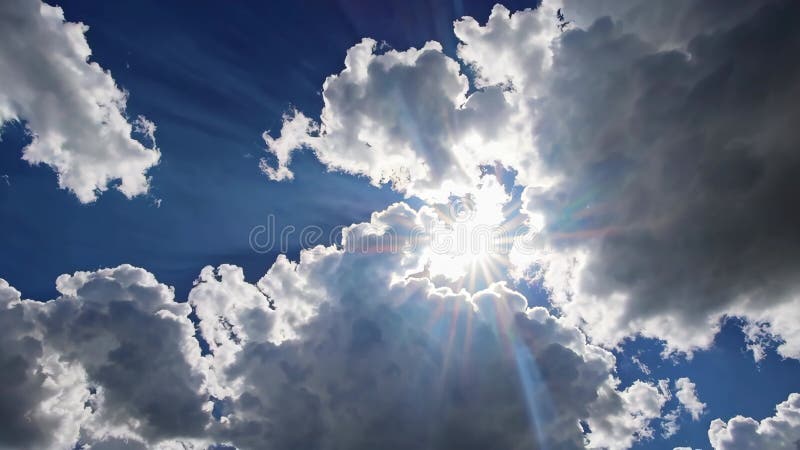 Bright Sunburst through Fluffy Clouds in Blue Sky. Nature and Optimism ...