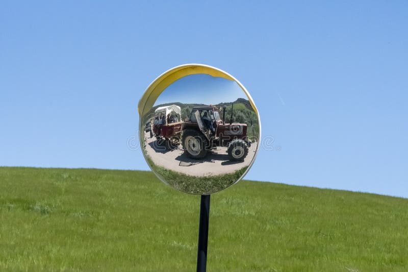 Reflection of a Tractor in a Convex Mirror Along a Rural Road in Bright ...