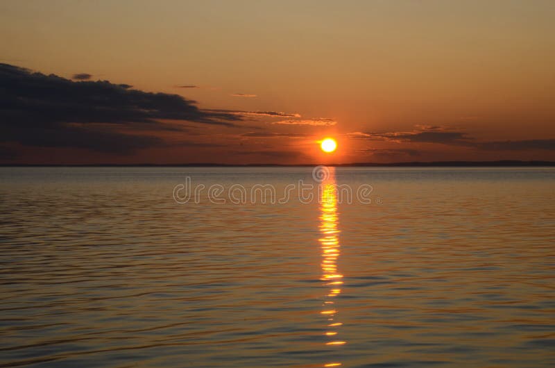 A Bright Sunny Path on the Lake, a Beautiful Sunset and the Setting Sun ...