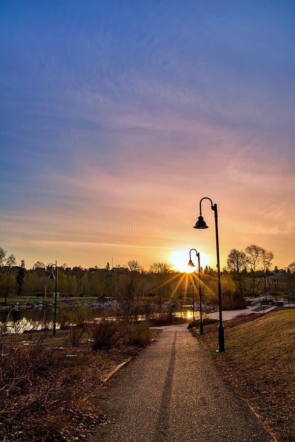 Sunrise Shining Over a Park Pathway Stock Image - Image of sunrise ...