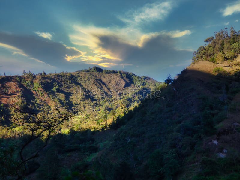 Sunset lights at the hills stock image. Image of clouds - 209205189