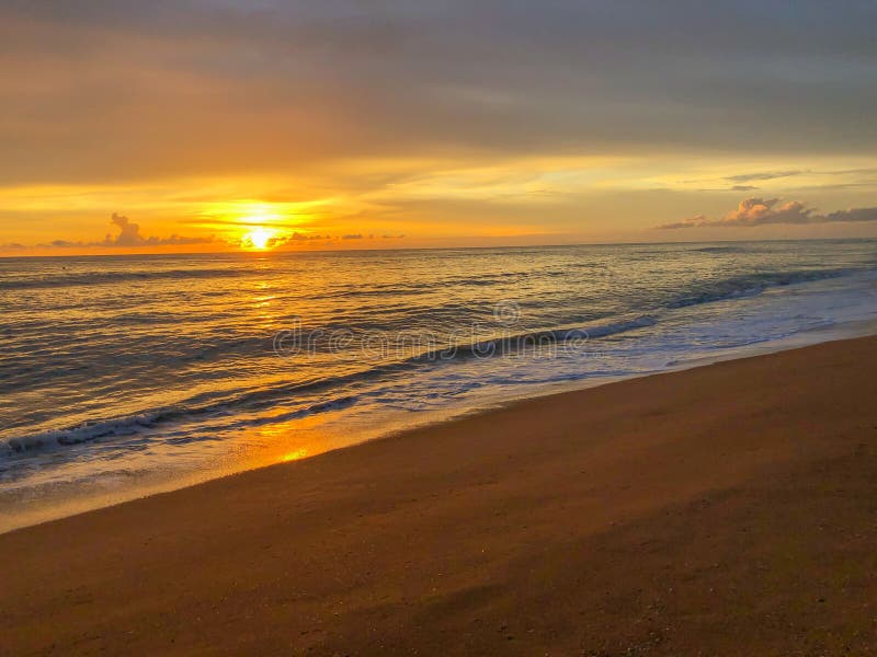 Bright Sunset Over the Ocean with a Golden Sky and Reflections on Water ...