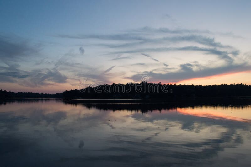 A Fall Sunset Turns a Lake into a Mirror Stock Photo - Image of plants ...