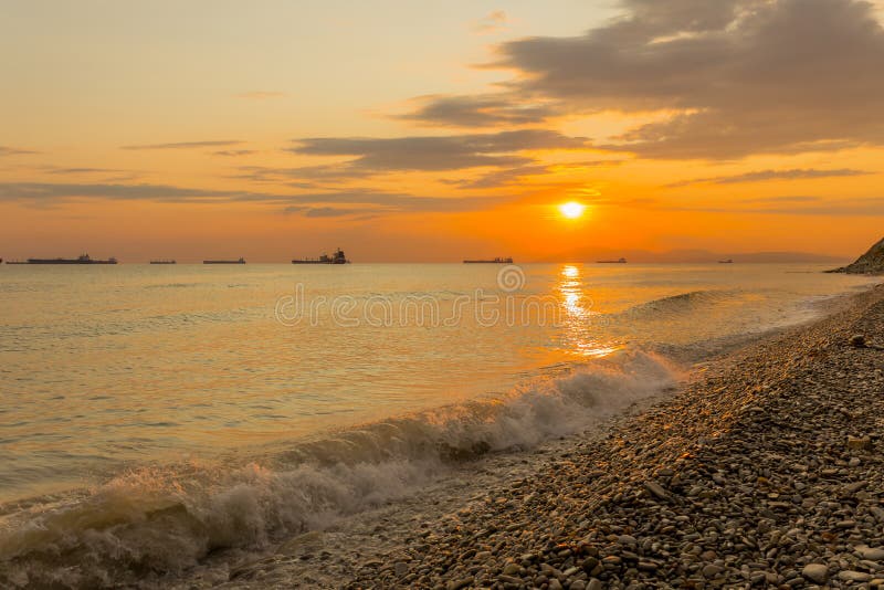 Bright Sunset with Small Yellow Sun Under the Sea Surface Stock Photo ...
