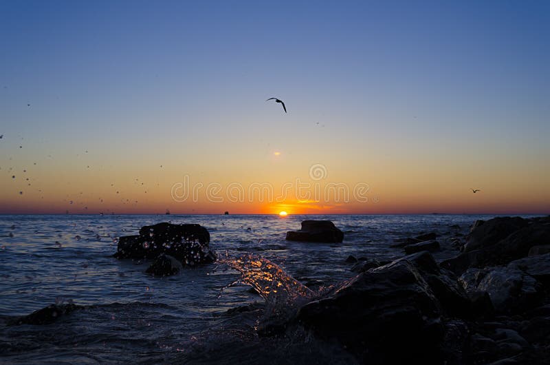 Bright Sunset Under the Sea with Waves Splashes. Stock Image - Image of ...