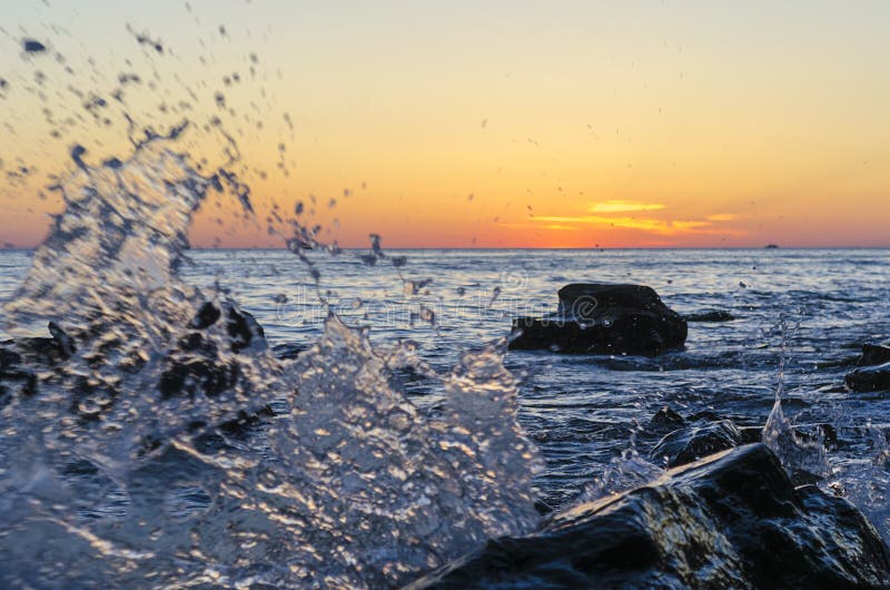 Bright Sunset Under the Sea with Waves Splashes. Stock Photo - Image of ...