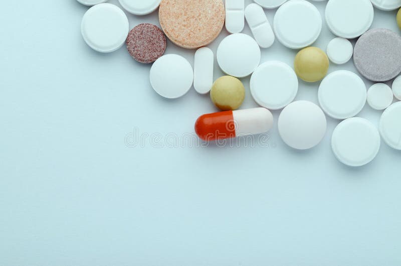 Bright Tablets of Different Shapes and Colors on a Blue Background ...