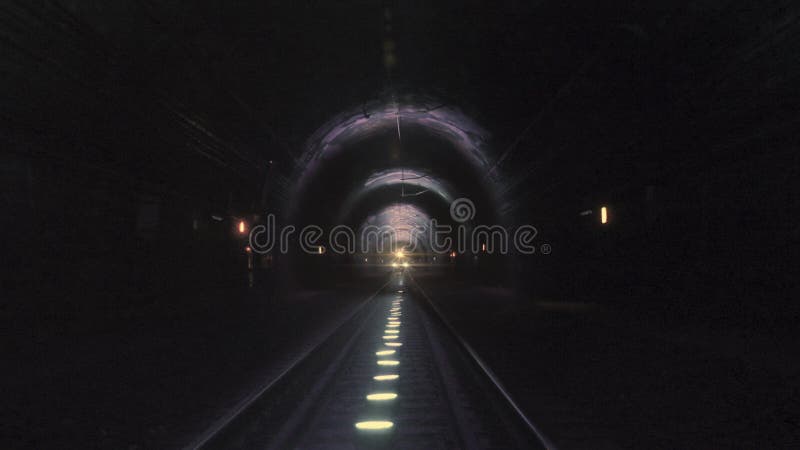 Bright Train Lights Coming Towards Camera in a Dark Railway Tunnel ...