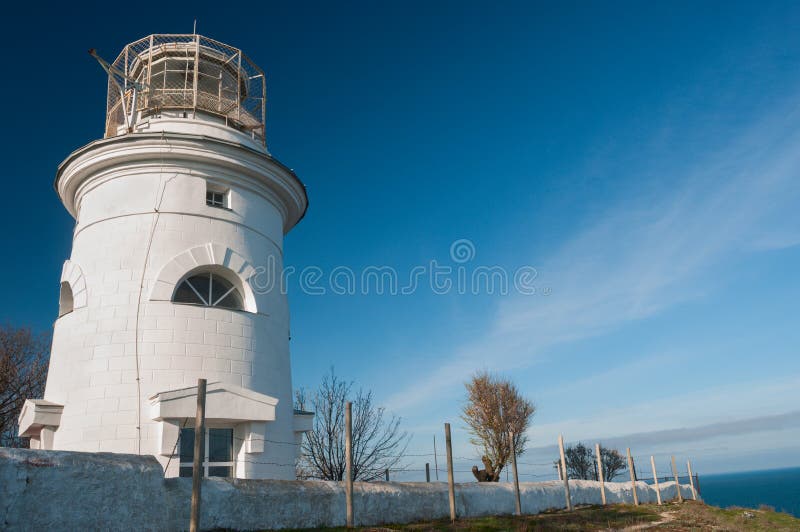 Bright White Lighthouse On Blue Sky Background Stock Image - Image of ...
