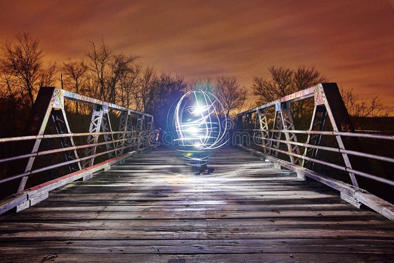 Bright White Sphere of Light Illuminates a White Bridge at Twilight ...